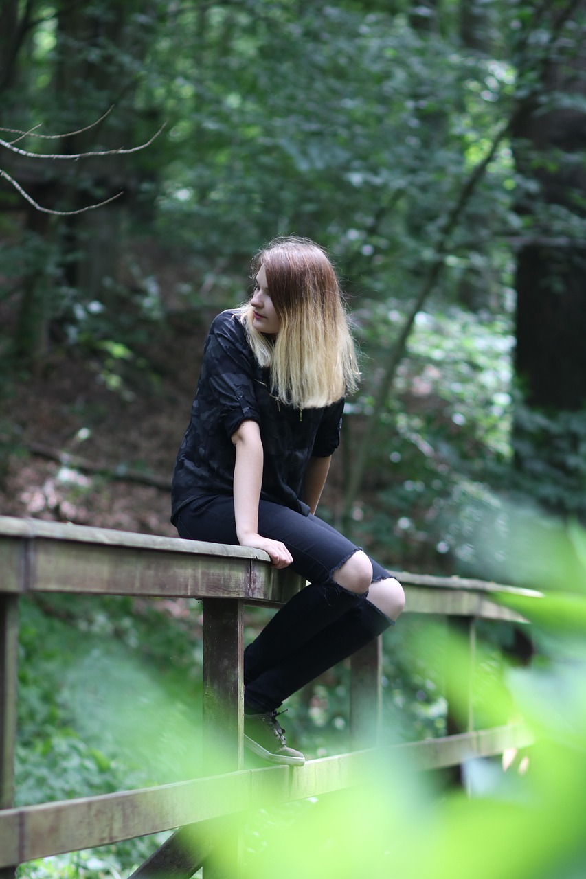 Woman Sitting On Bridge